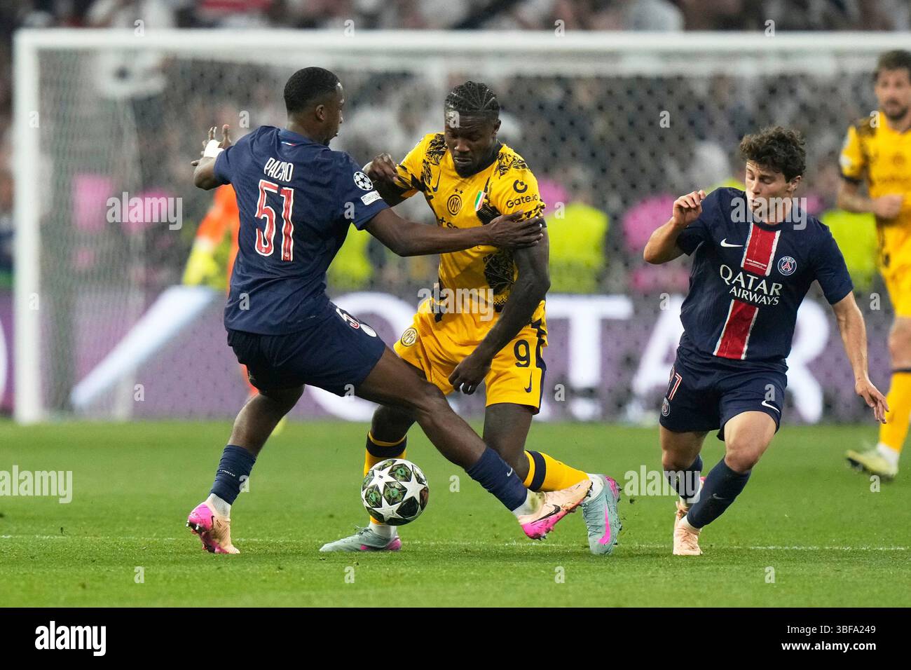 PSG's Willian Pacho, left, tries to tackle Inter Milan's Marcus Thuram ...