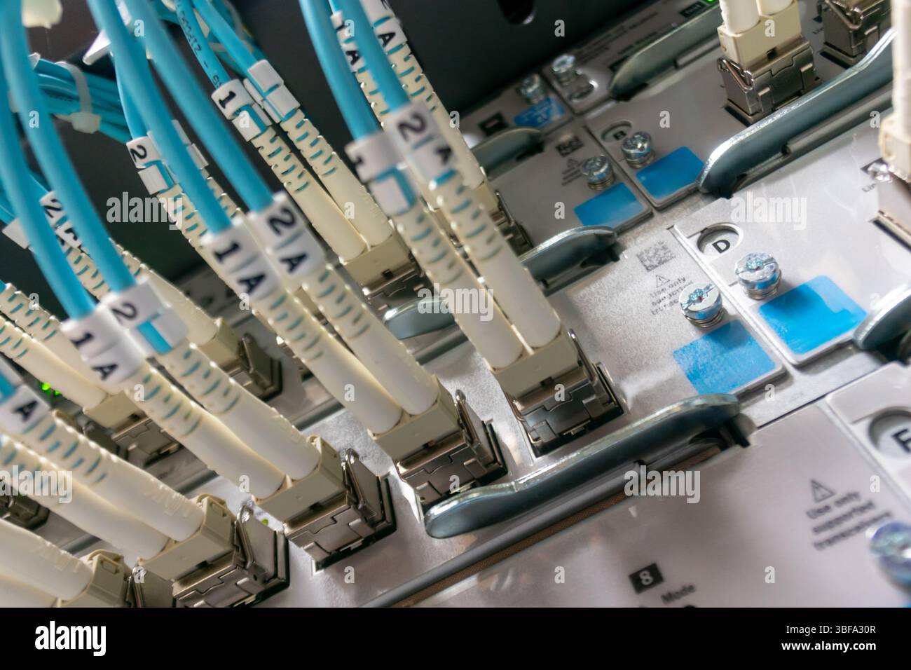Close-up view of fiber optic cables connected in a data center ...