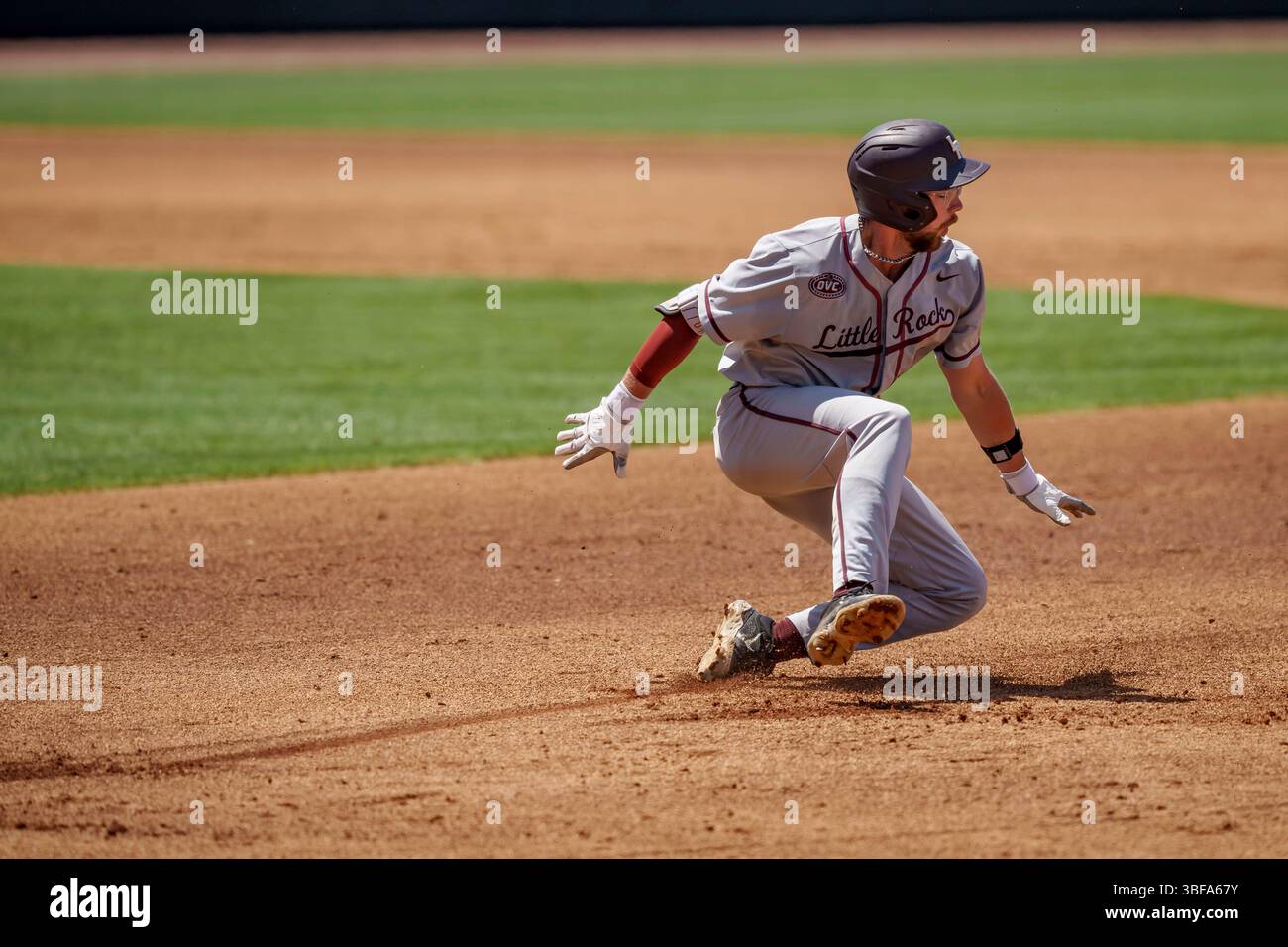 Little Rock utility Ty Rhoades (25) slips after rounding first base ...