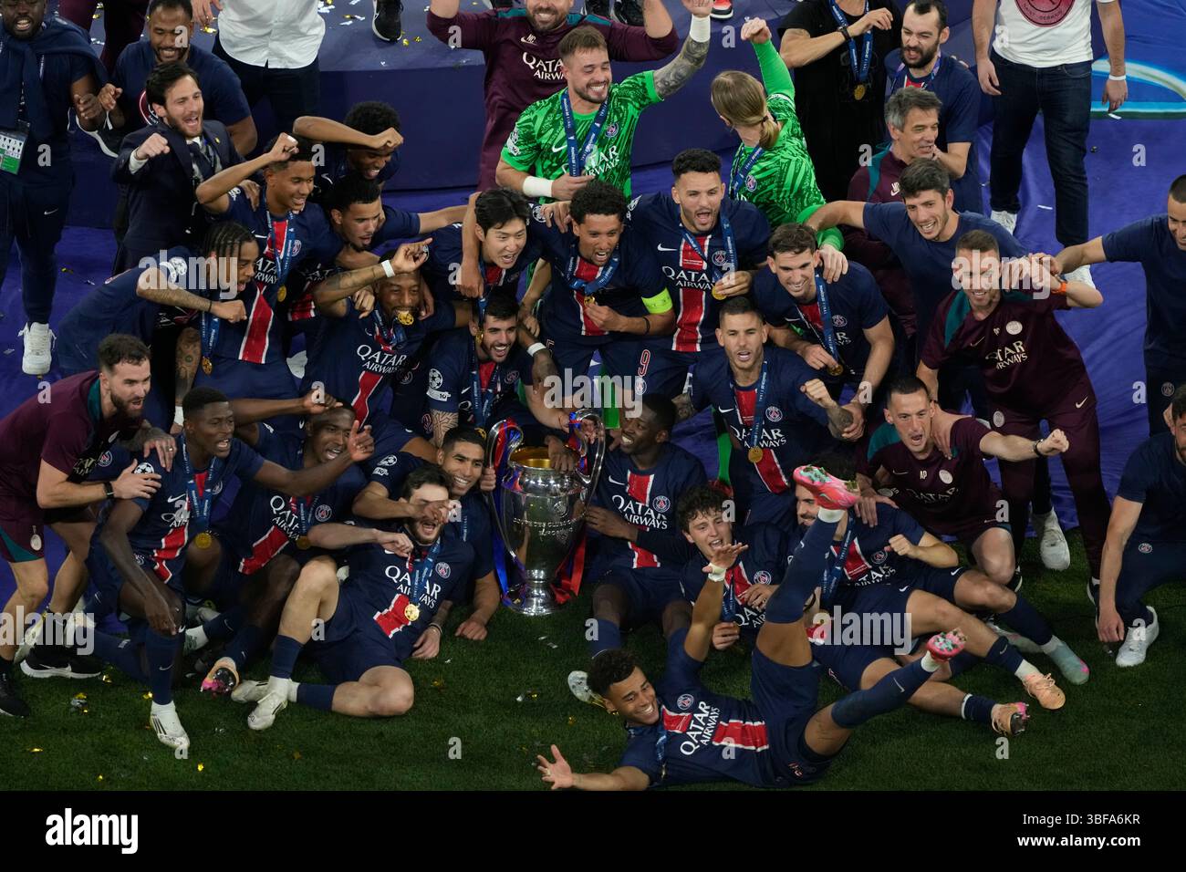 Players of PSG pose with the trophy after winning the Champions League ...