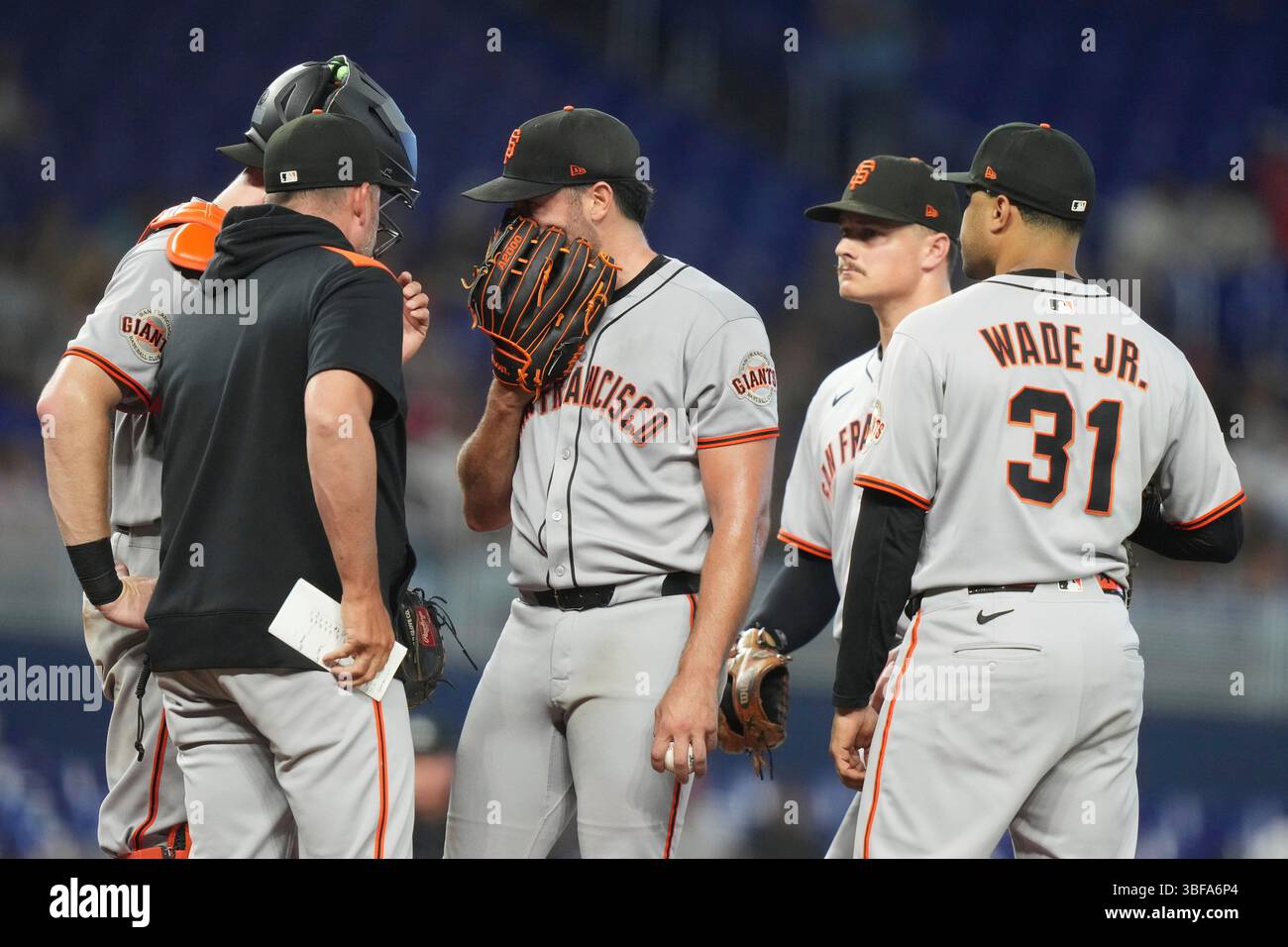 San Francisco Giants starting pitcher Robbie Ray, center, talks on the ...