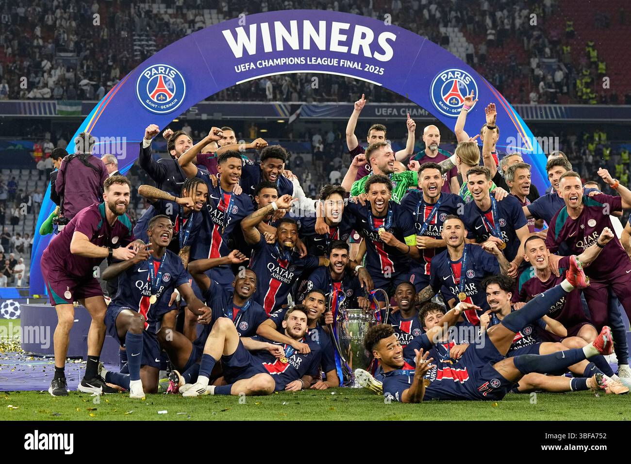 Paris Saint-Germain players pose for a photo with the trophy as they ...