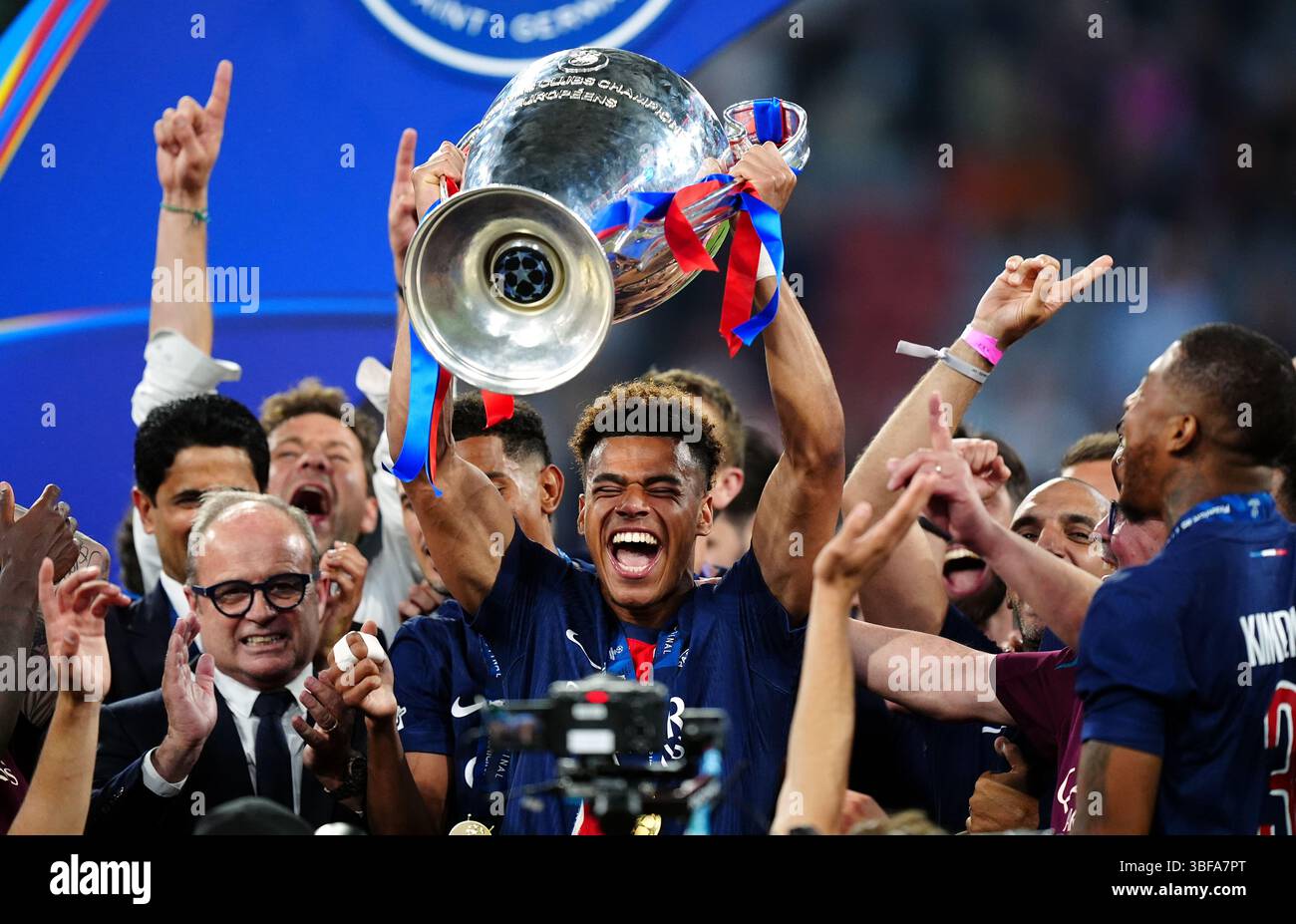 Paris Saint-Germain's Desire Doue with the trophy after winning the ...