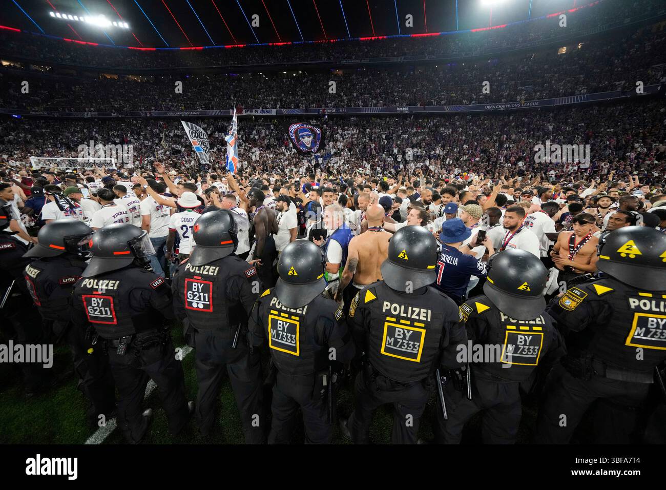 Police block PSG supporters invading the pitch at the end of the ...