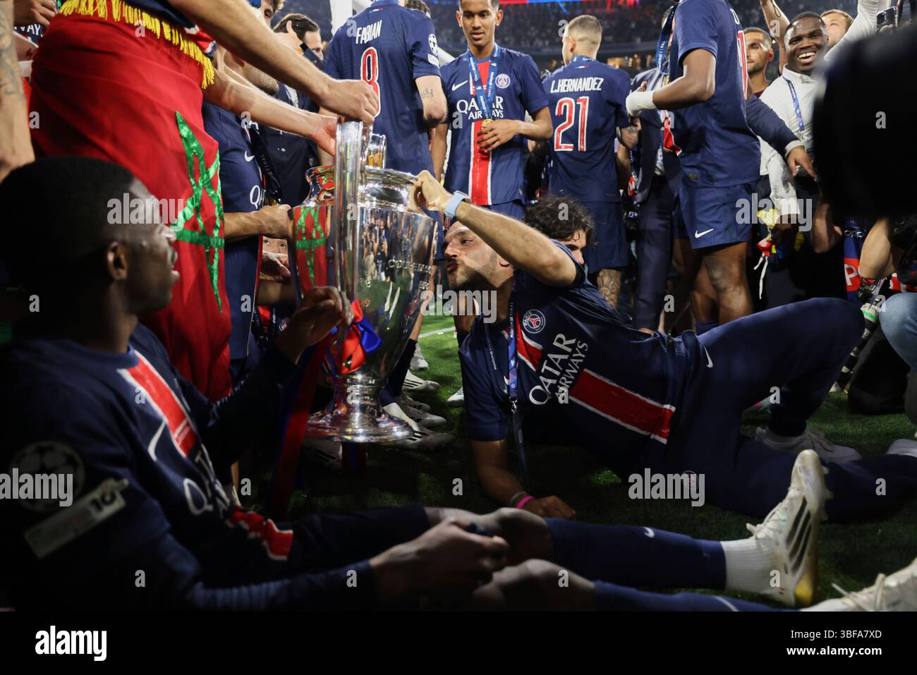 PSG players celebrate with a trophy after the Champions League final ...