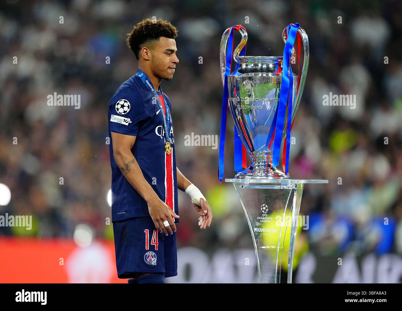 Paris Saint-Germain's Desire Doue with the trophy after winning the ...