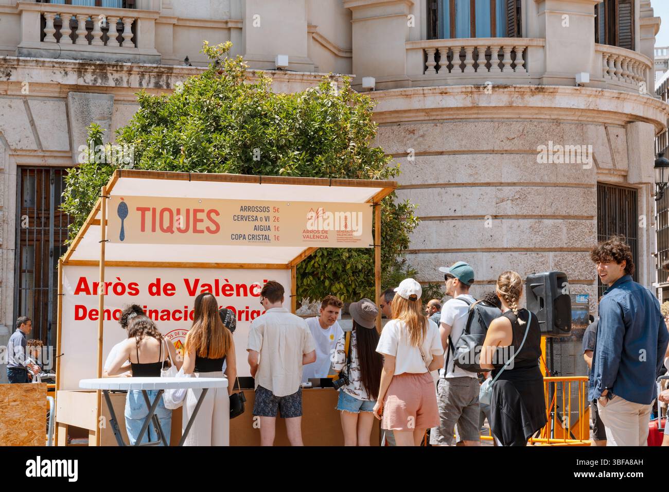 Visitors stand in line at a ticket booth at Fiesta del Arroz, Food ...