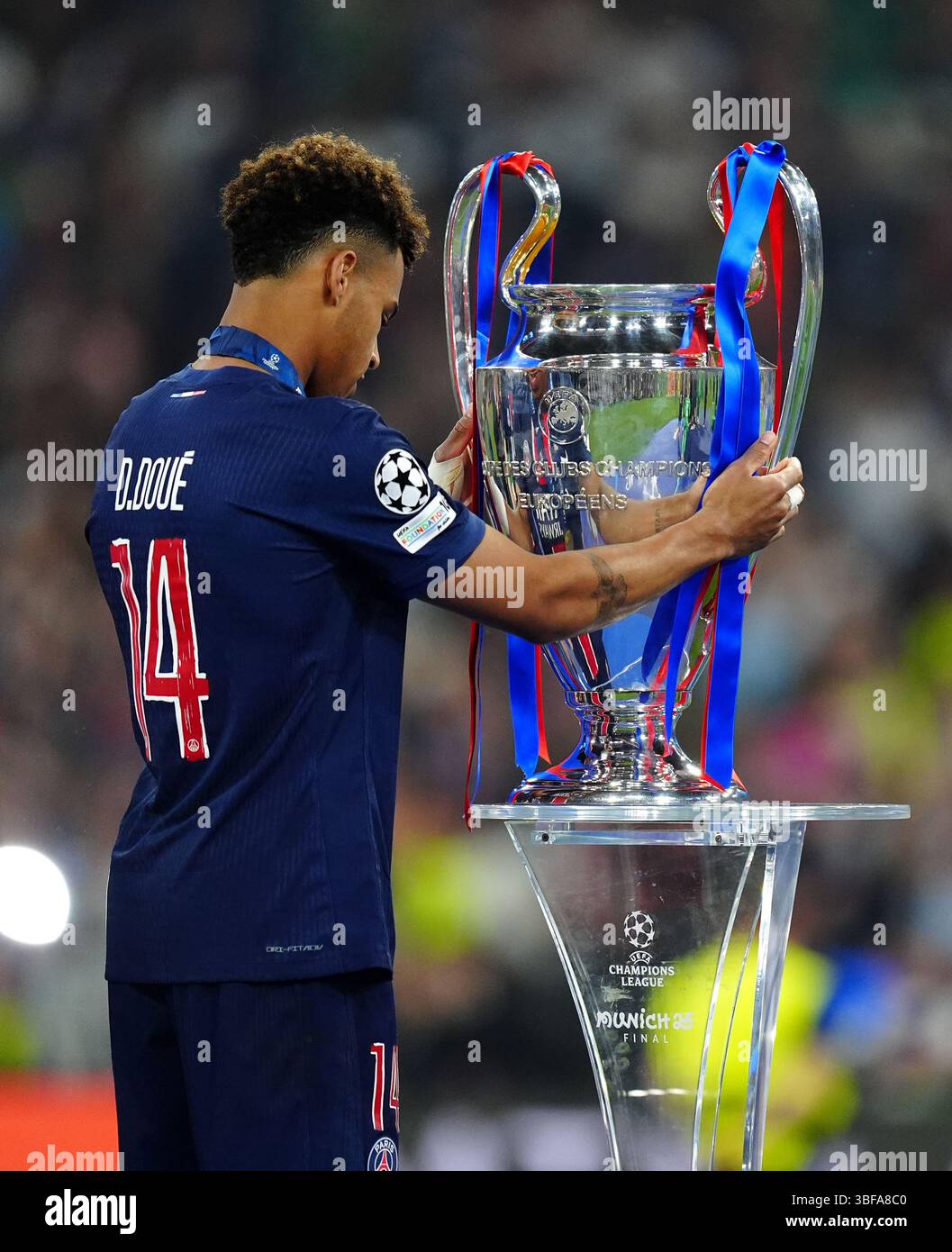Paris Saint-Germain's Desire Doue with the trophy after winning the ...