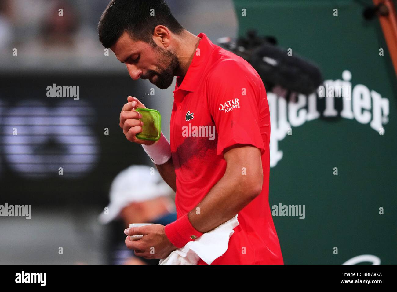 Serbia's Novak Djokovic eats from a container in between games against ...