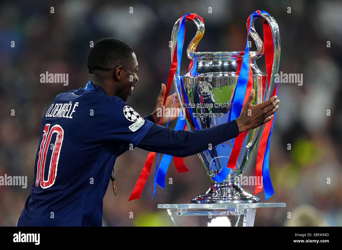 Paris Saint-Germain's Ousmane Dembele with the trophy after winning the ...