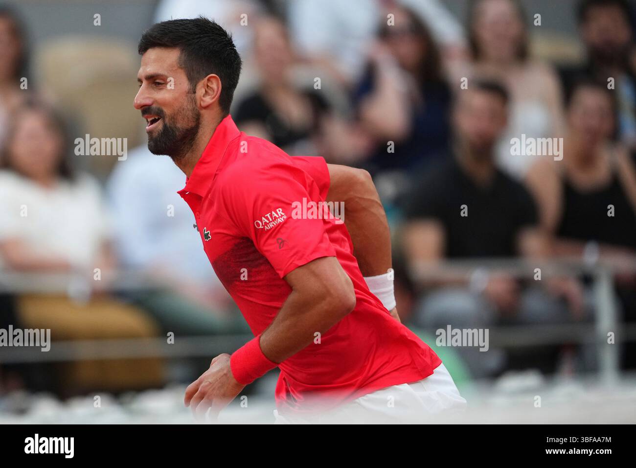 Serbia's Novak Djokovic smiles as he is unable to reach the short ball ...