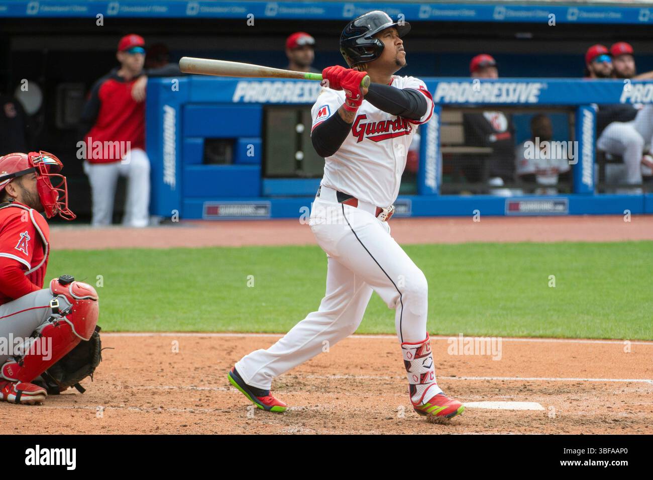 Cleveland Guardians' Jose Ramirez, right, watches his solo home run off ...