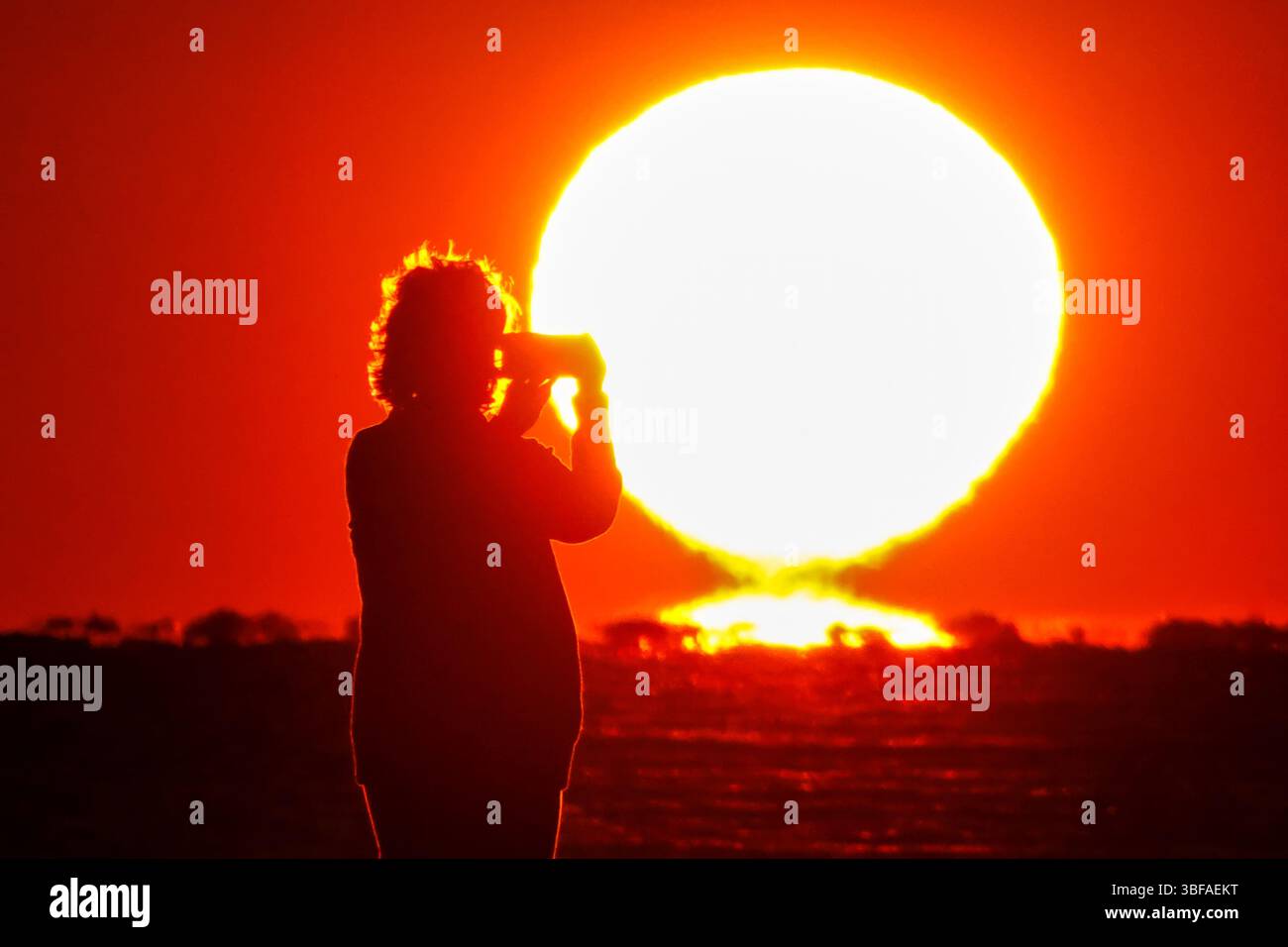 Isle Of Palms, United States. 31st May, 2025. A woman silhouetted by ...