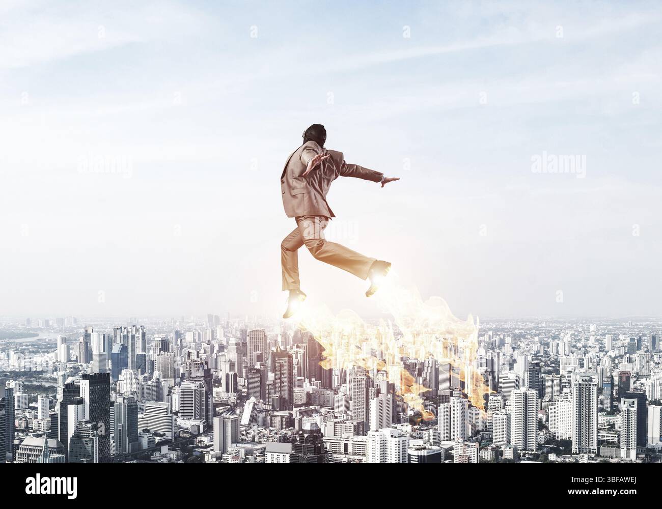 Expressive businessman in suit and aviator hat flying in blue sky as ...