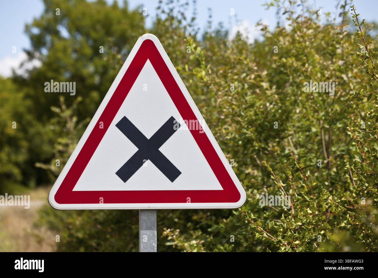 Triangular crossroads road sign on a country road junction Stock Photo ...