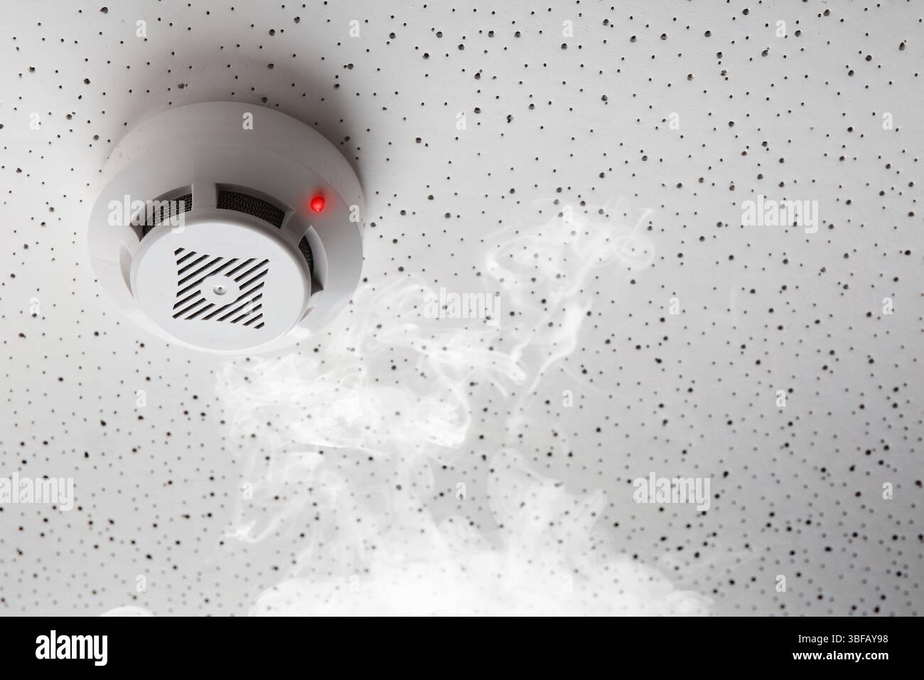 Fire alarm system detector on ceiling triggered by smoke Stock Photo ...