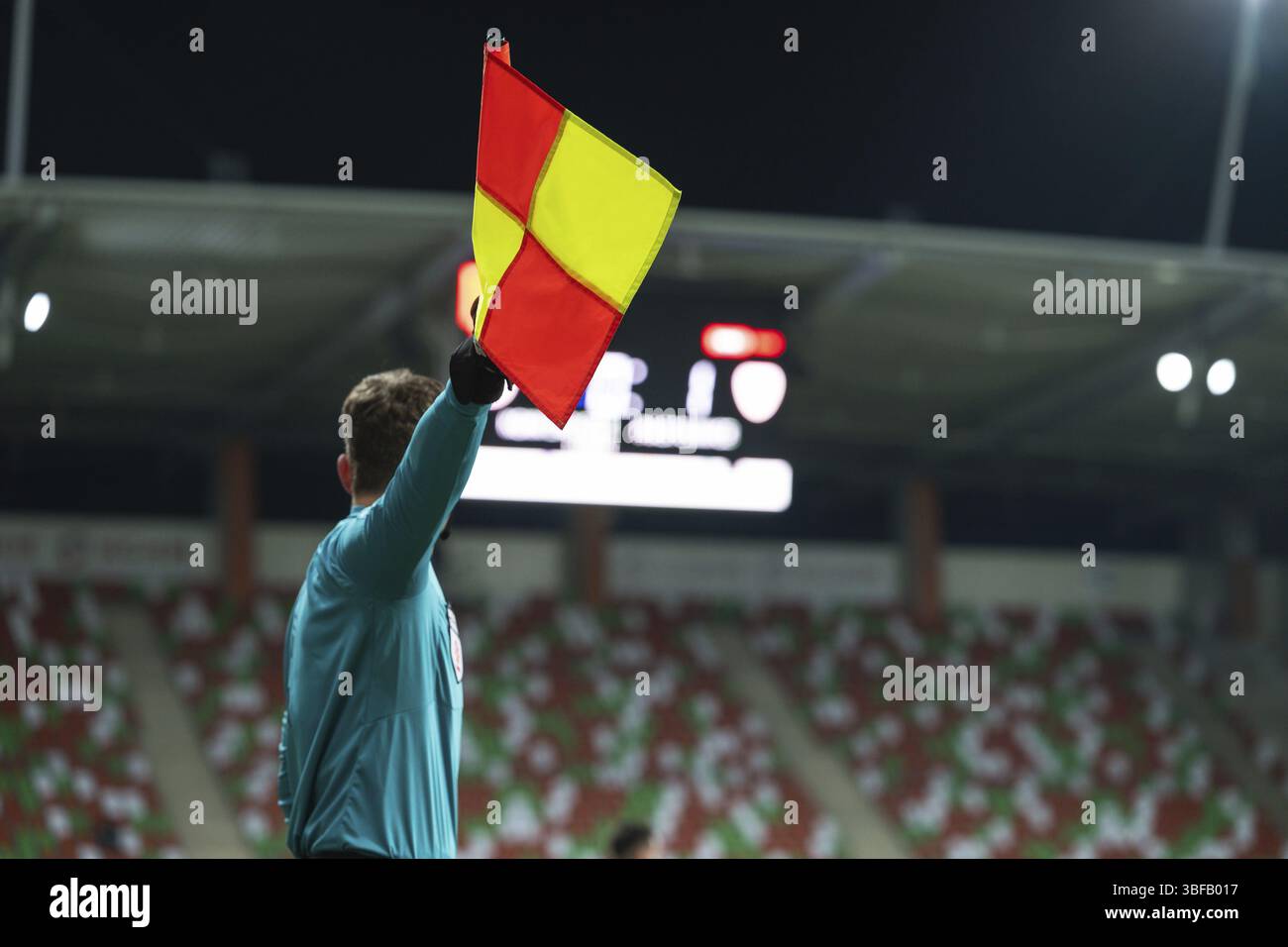 Soccer touchline referee with the flag during match at the football ...