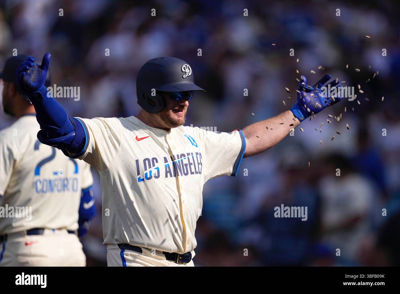 Los Angeles Dodgers' Max Muncy has seeds thrown at him after hitting a ...