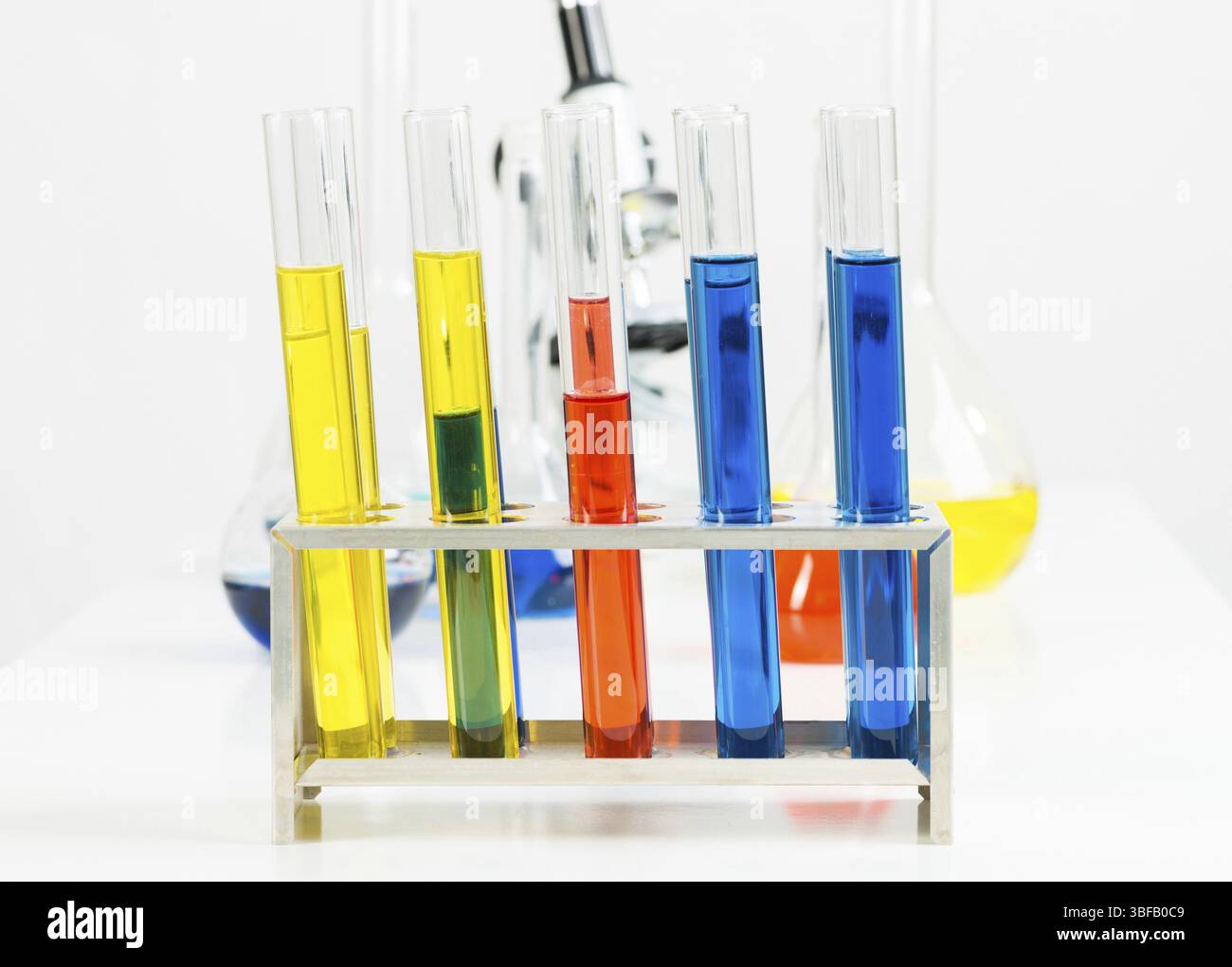 Chemistry lesson in school lab. Glass test tubes with color reagents ...