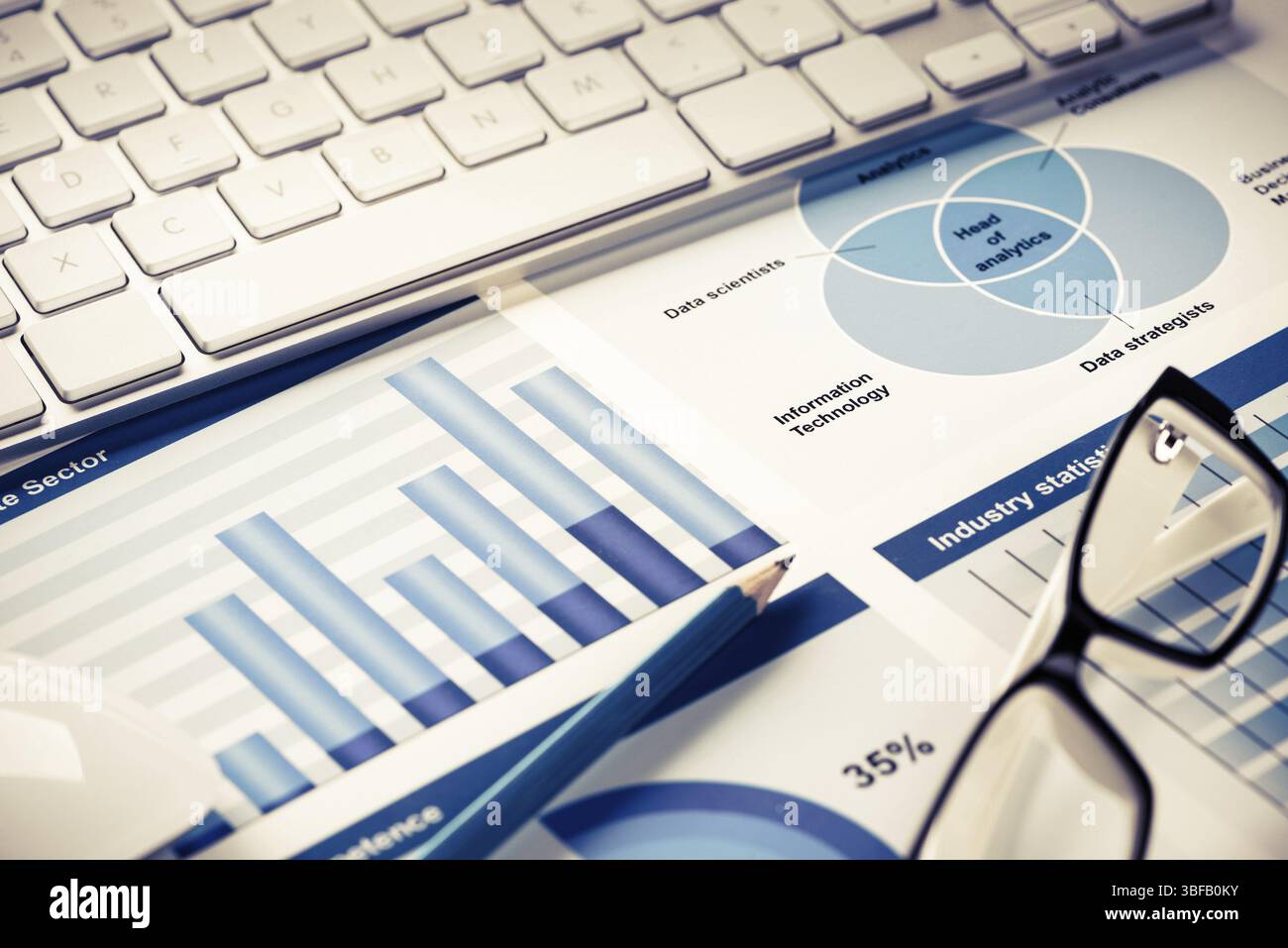 Business workplace with keyboard mouse and papers with graphs and ...