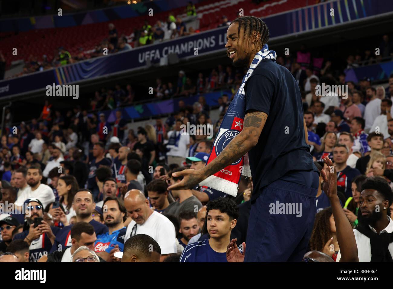 Munich, Germany May 31, 2025: William Pacho of PSG holds his daughter in his arms after victory ...