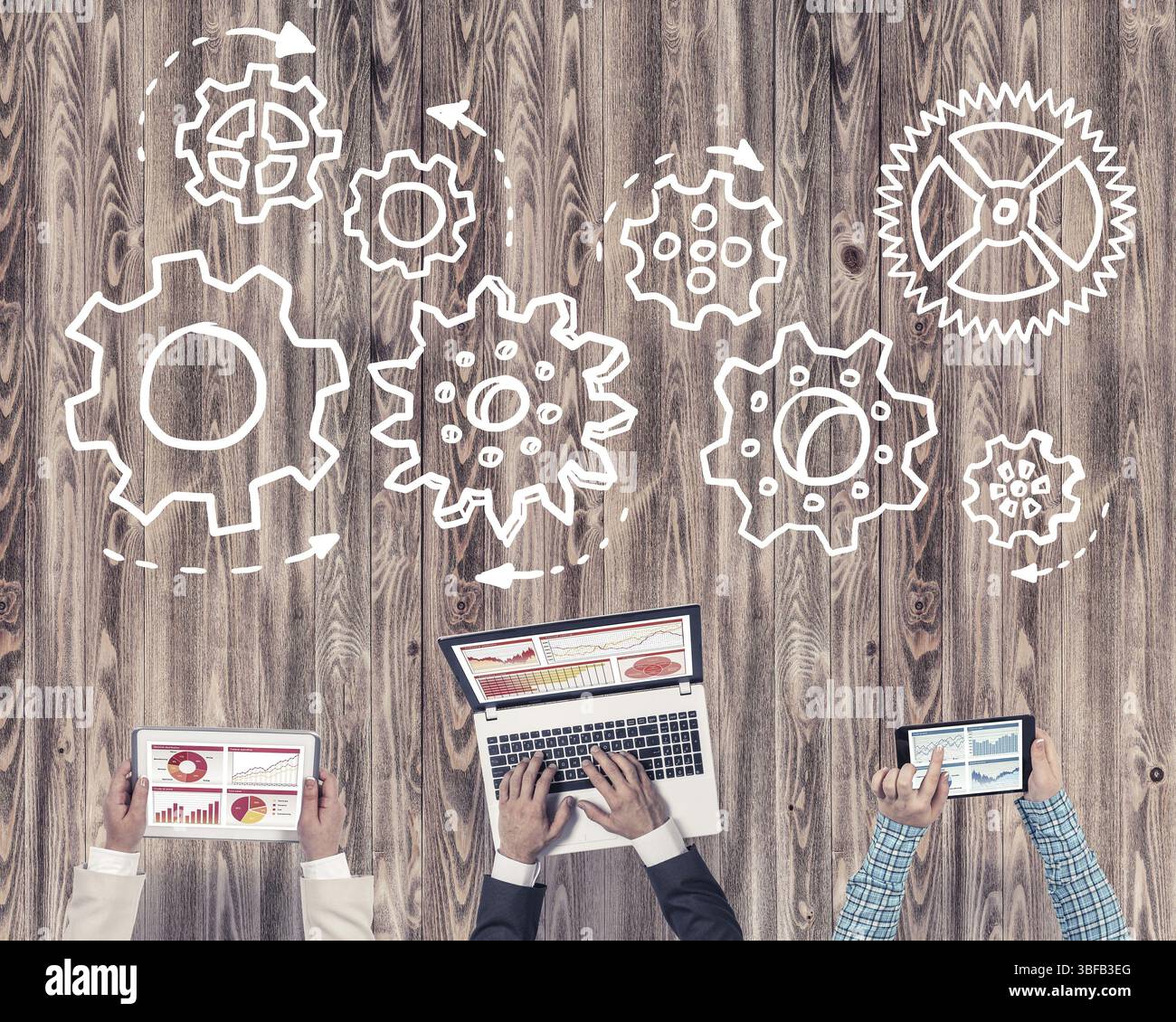Group of three people with devices in hands working together as symbol ...