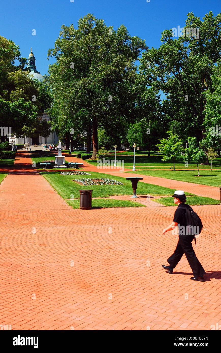 A female midshipman walks across the campus of the US Naval Academy in ...