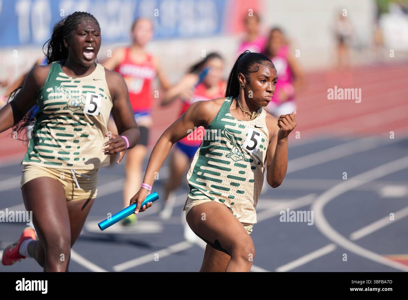Nevaeh Lewis takes the handoff from Aniyah Brooks on the third leg of ...
