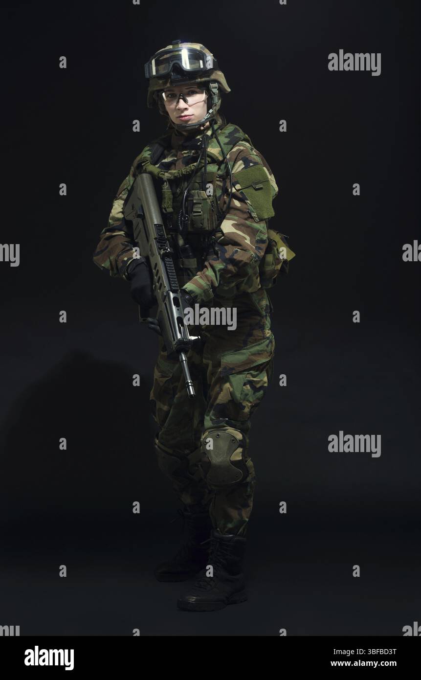 NATO soldier in full gear. Military woman over black background Stock ...