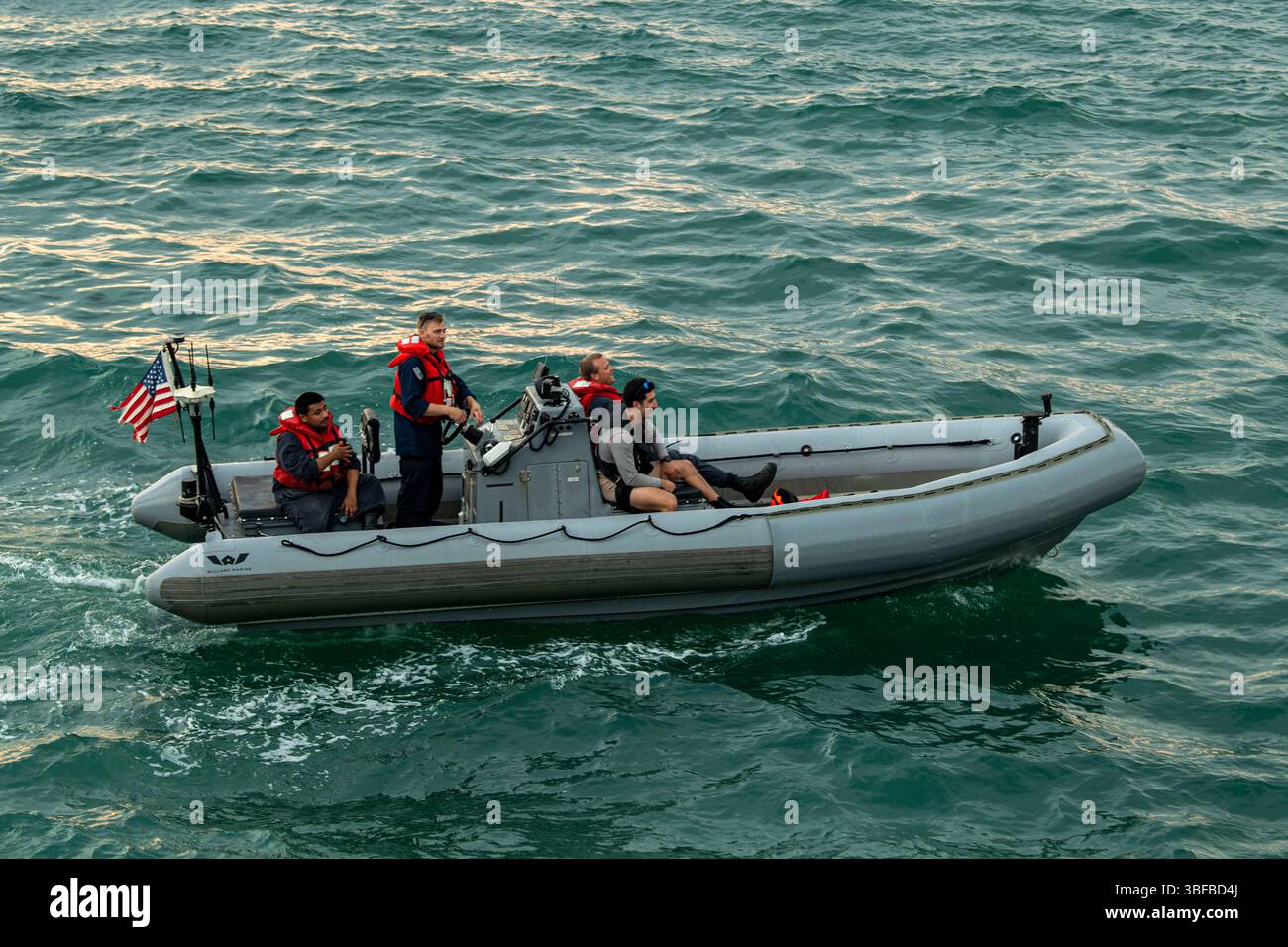 Sailors sail a rigid-hull inflatable boat as the Arleigh Burke-class ...