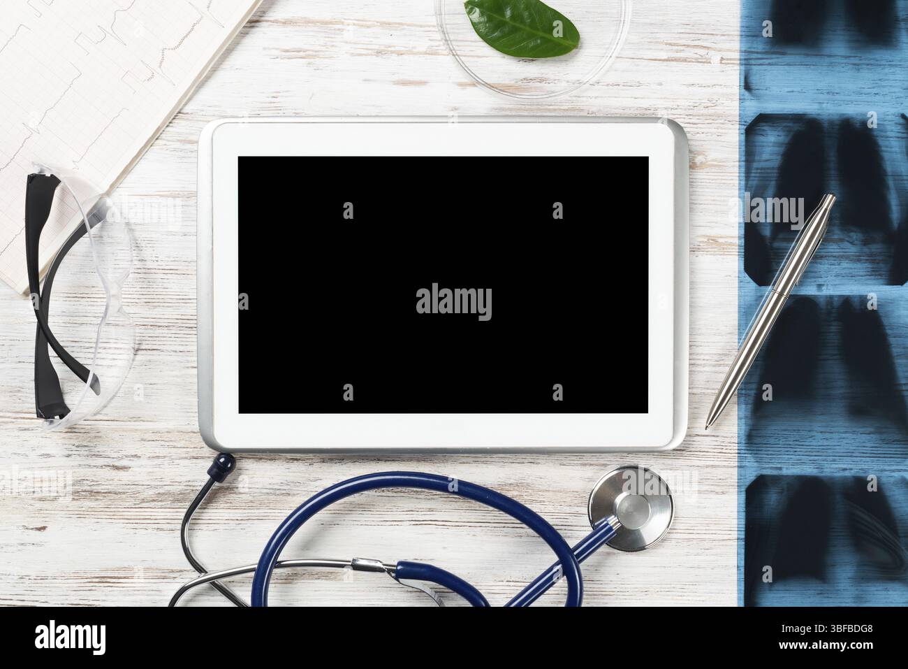 Mock up of doctors desktop with medical supplies. Tablet computer, x ...