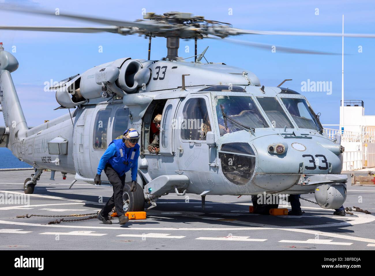 Aviation Boatswains Mate 3rd Class Derek Torres-Pelet chocks and chains ...