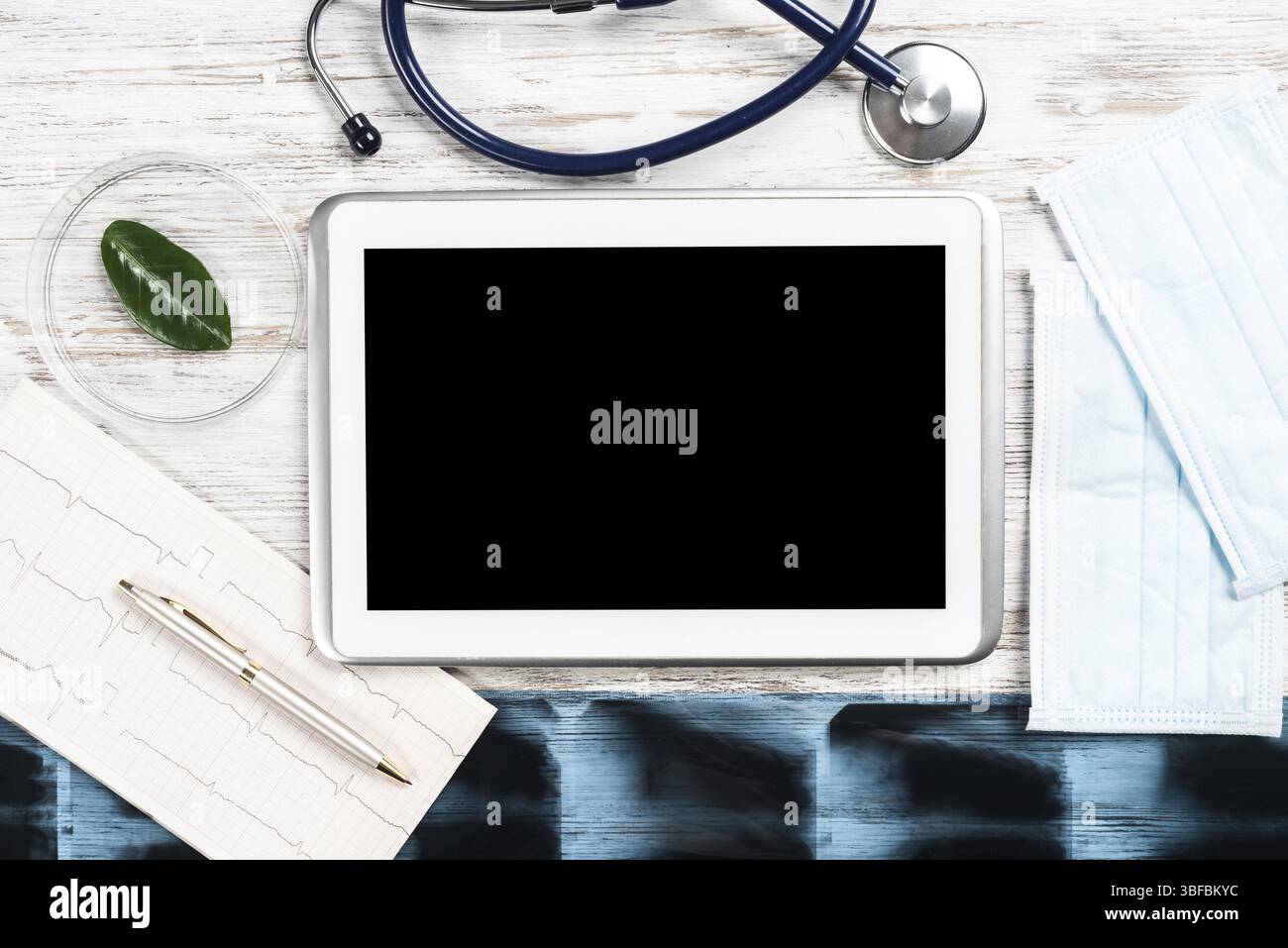 Mock up of doctors desktop with medical supplies. Tablet computer, x ...