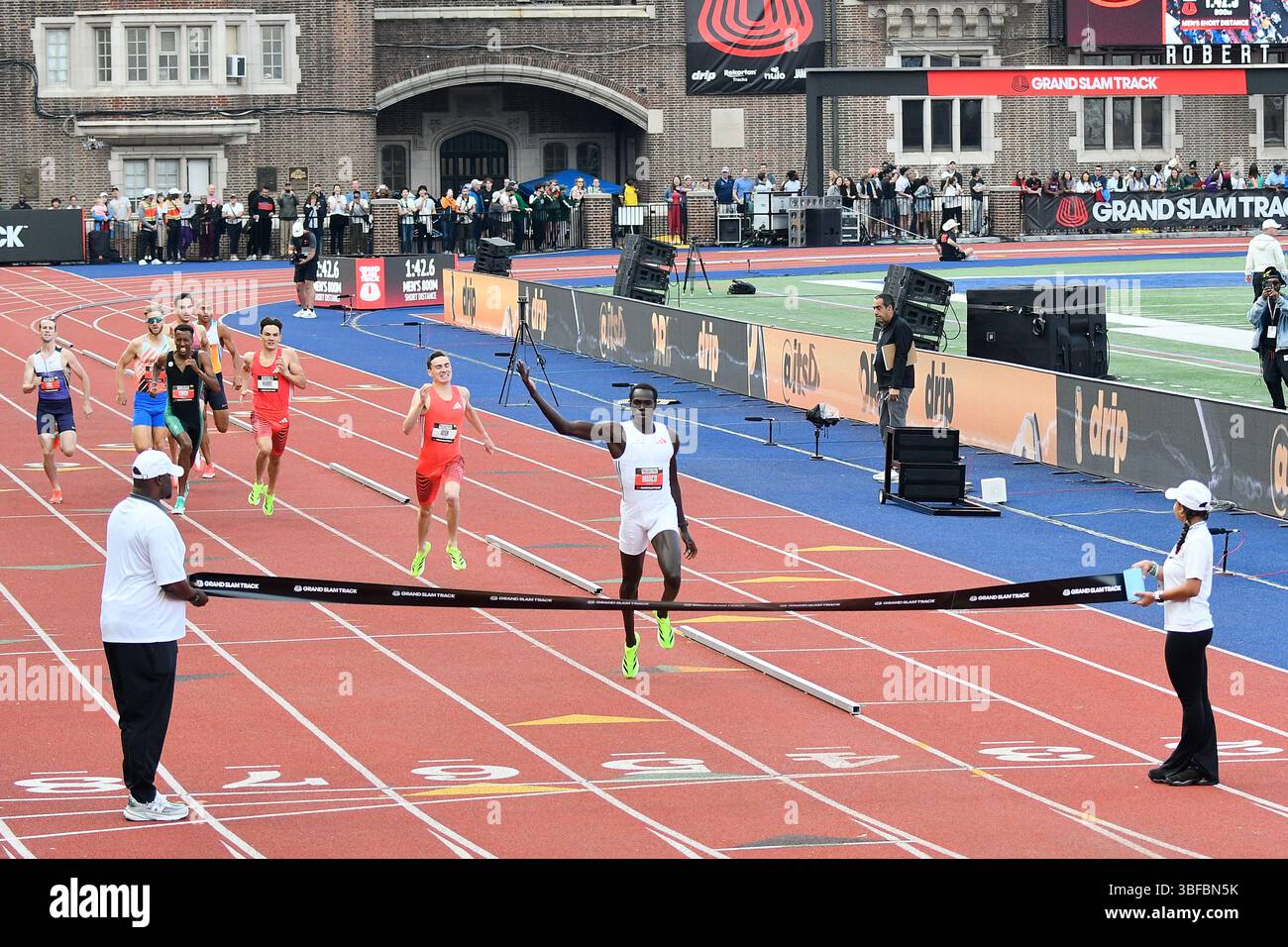Marco Arop celebrates before crossing the finish line in the Men’s ...