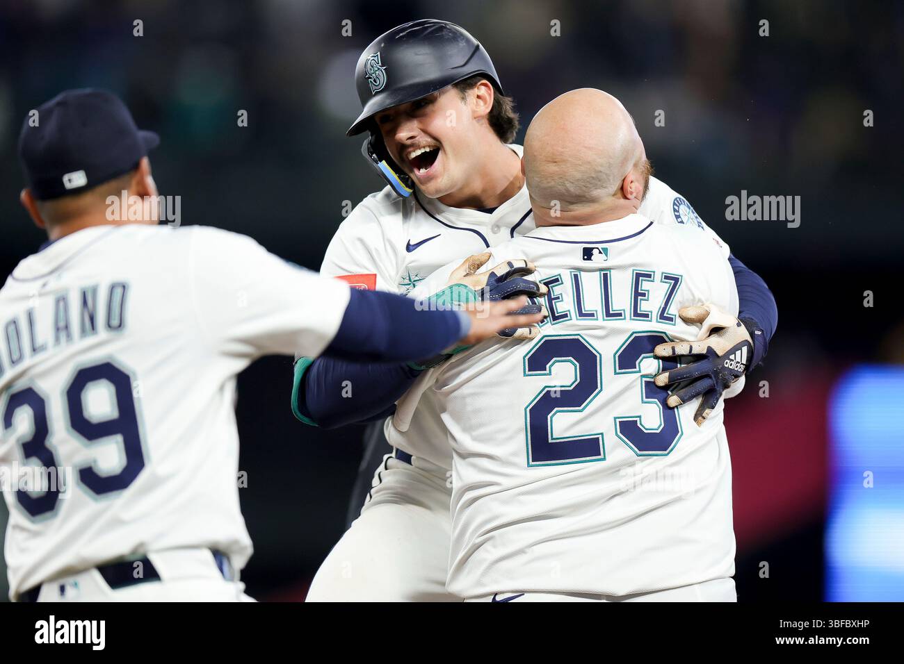 Seattle Mariners second baseman Cole Young, center, celebrates with ...