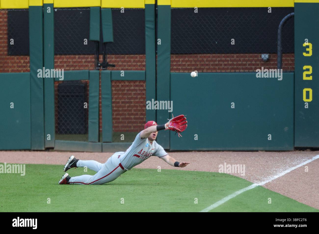 May 31, 2025: Arkansas outfielder Logan Maxwell (22) makes a diving ...