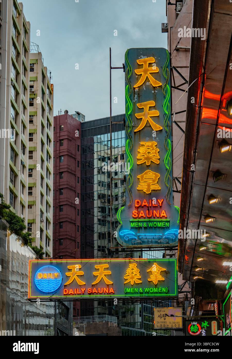 Colorful neon advertisement signs along buildings and businesses ...