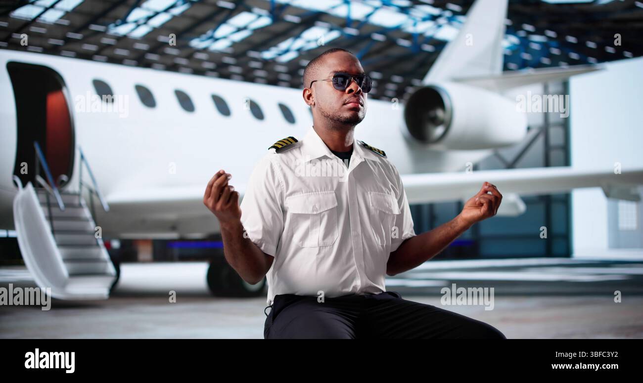 African American Pilot Meditating And Praying Before Flight Stock Photo ...