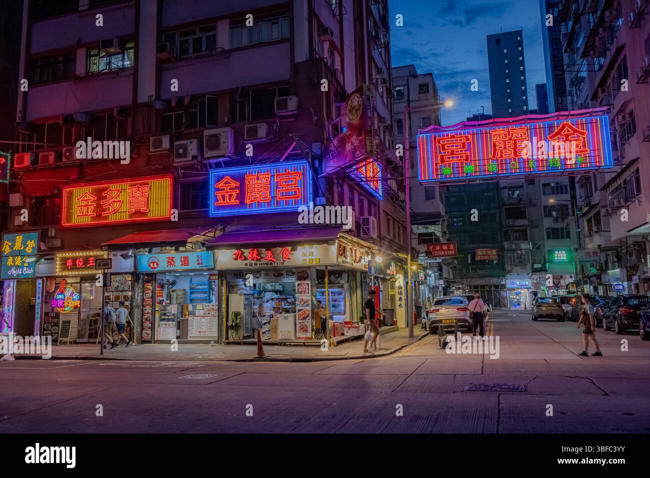 Colorful neon advertisement signs along buildings and businesses ...