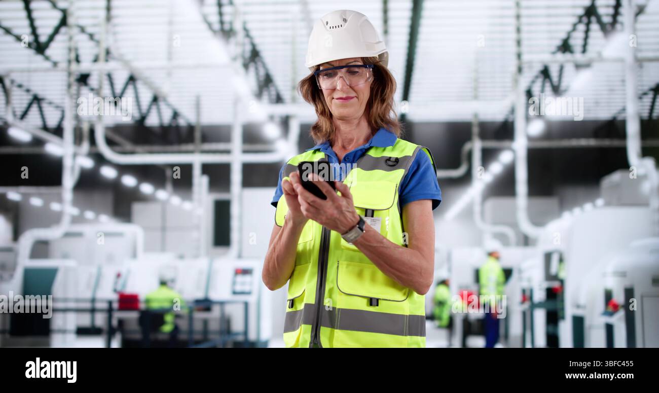 Female Factory Worker Inspecting Automated Production Line While Using ...