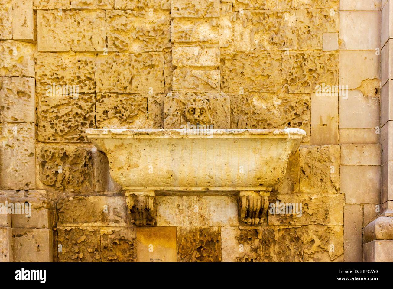 Stone Wall with an Ancient Ornamental Basin Sculpture in Historic ...