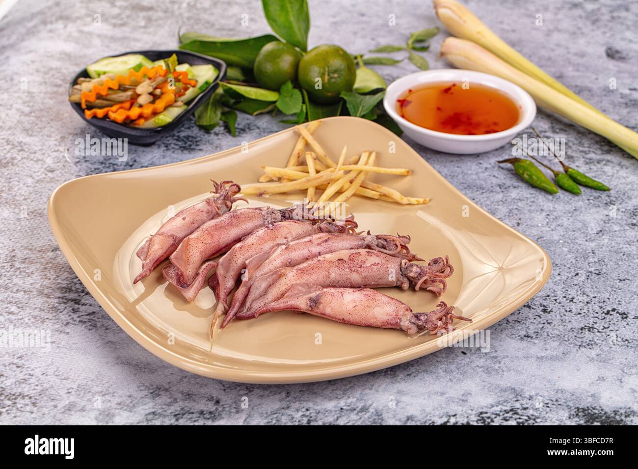 Boiled wild mini calamari snack with ginger Stock Photo - Alamy