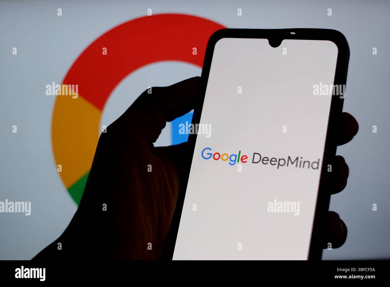 In this photo illustration, the Google DeepMind AI logo seen displayed on a smartphone and in ...