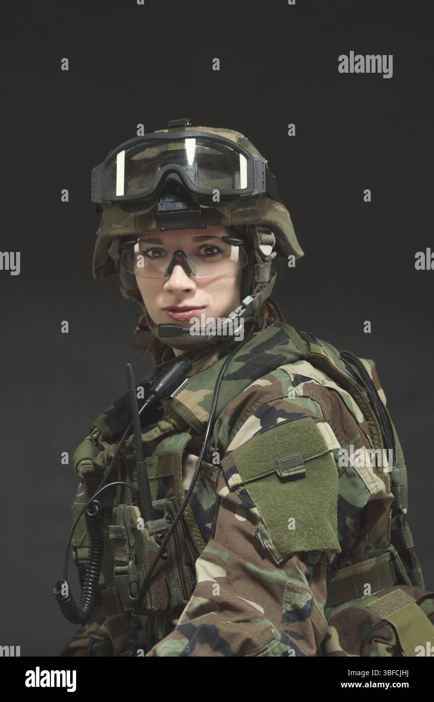 NATO soldier in full gear. Military woman over black background Stock ...