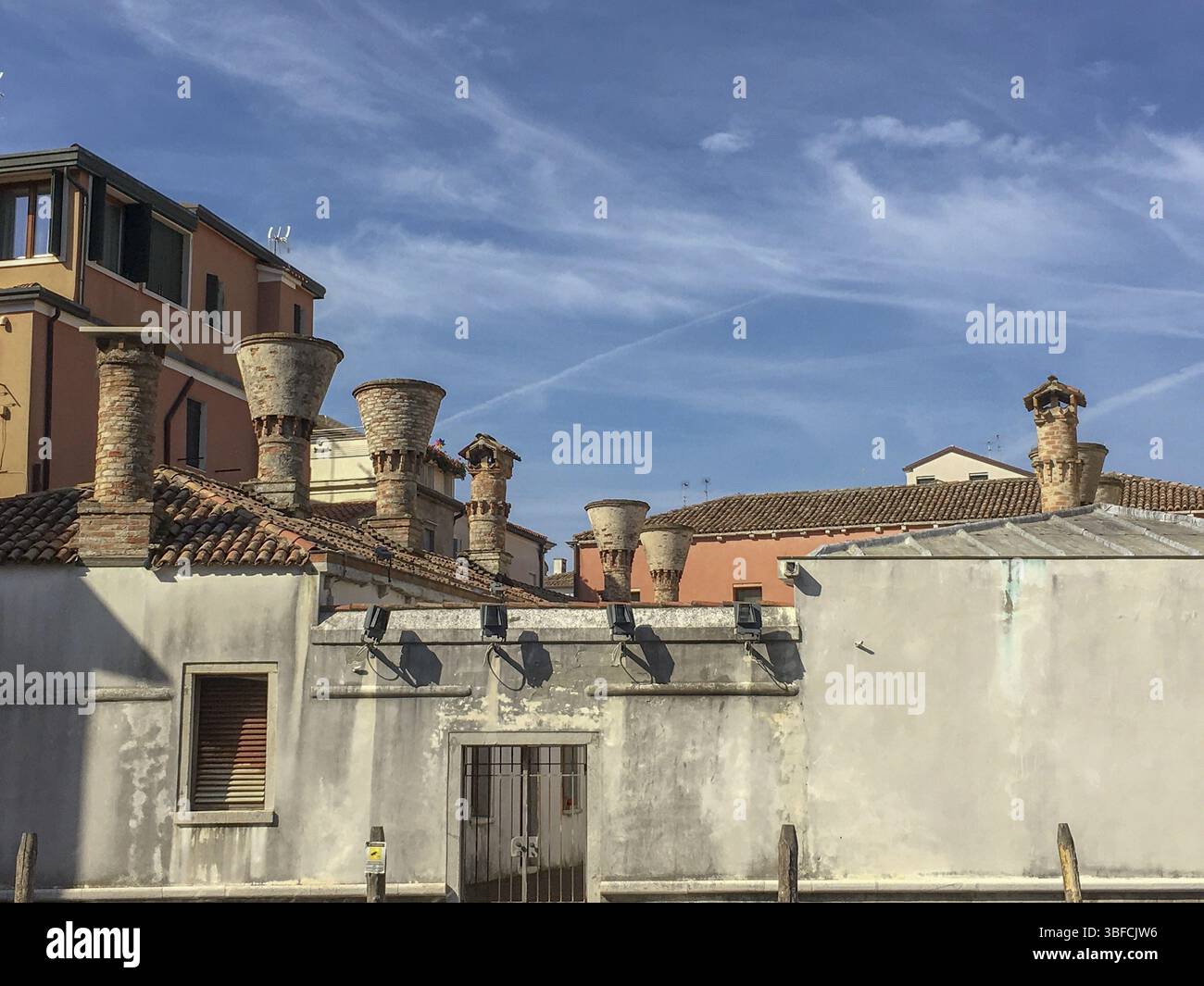 Venice roofs with an old house in front Stock Photo - Alamy