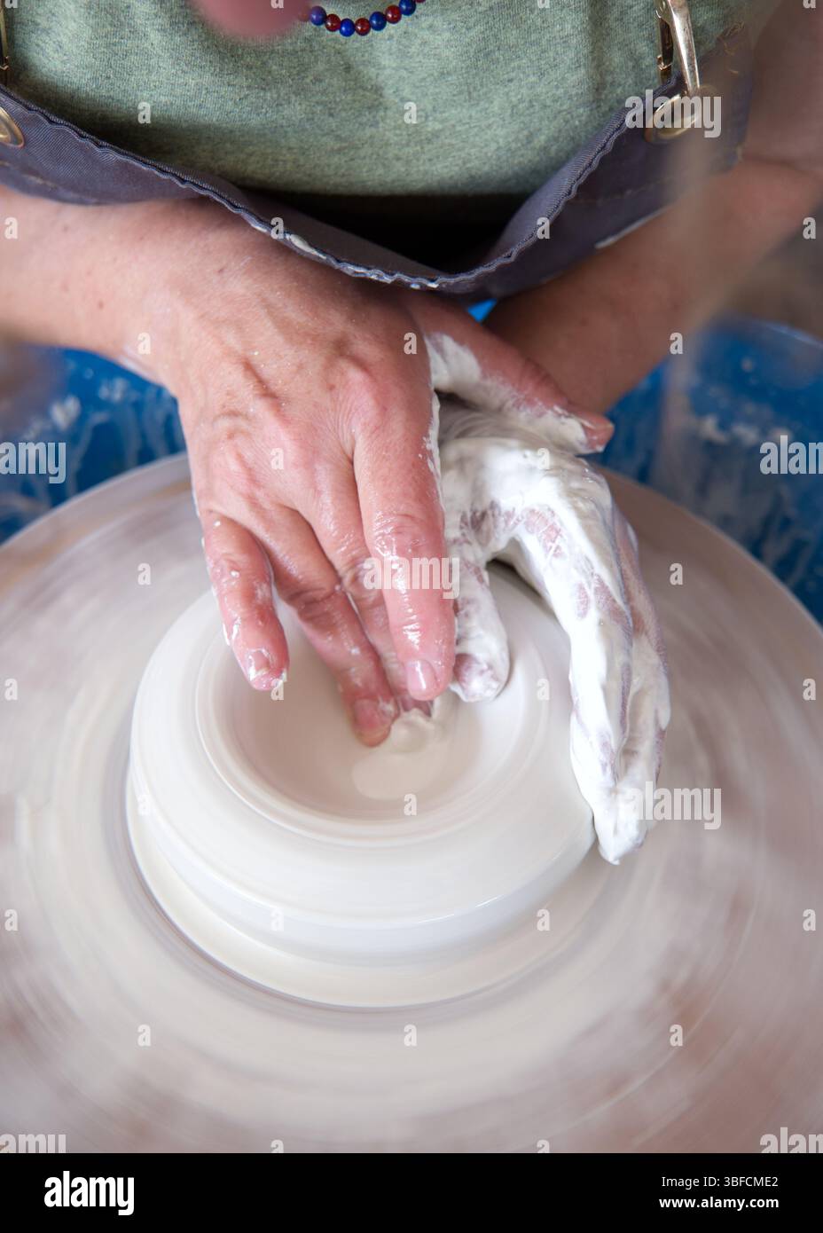 Throwing porcelain clay on a pottery wheel Stock Photo - Alamy