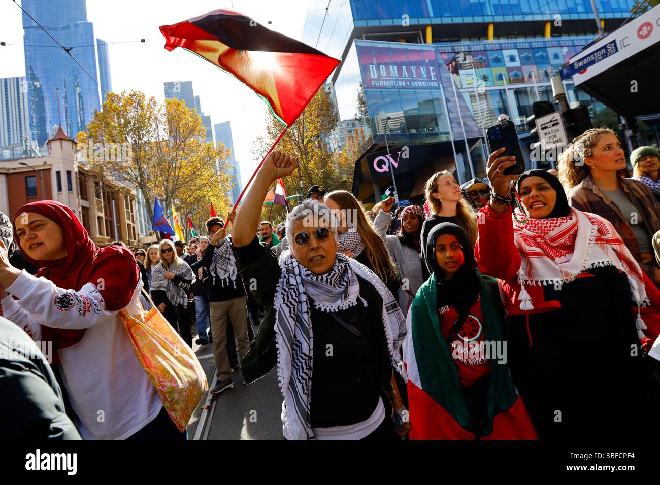 A protester raises her fist during the rally. A protest march in ...