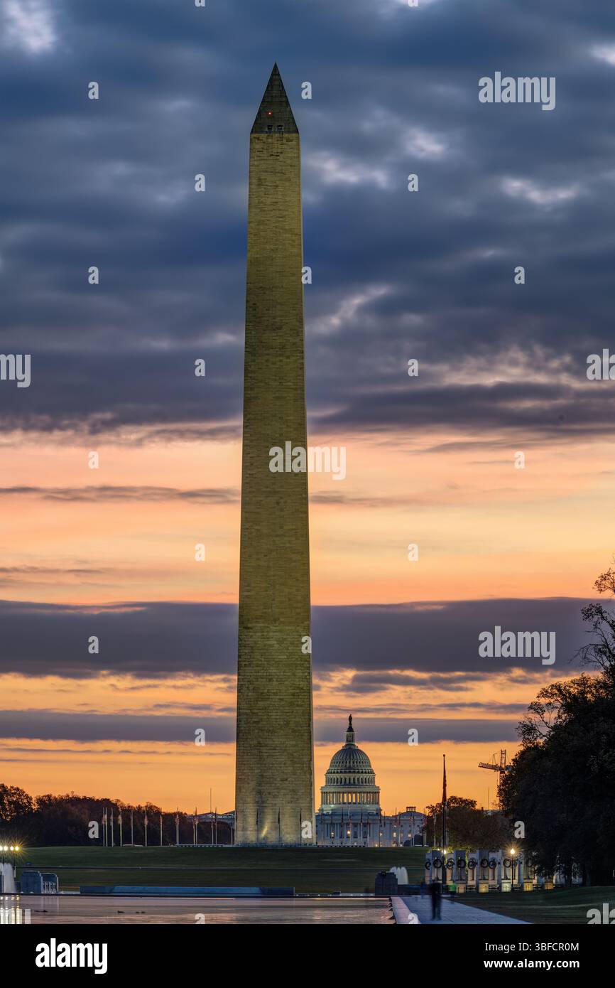 The illuminated Washington Monument before sunrise with the Capitol ...