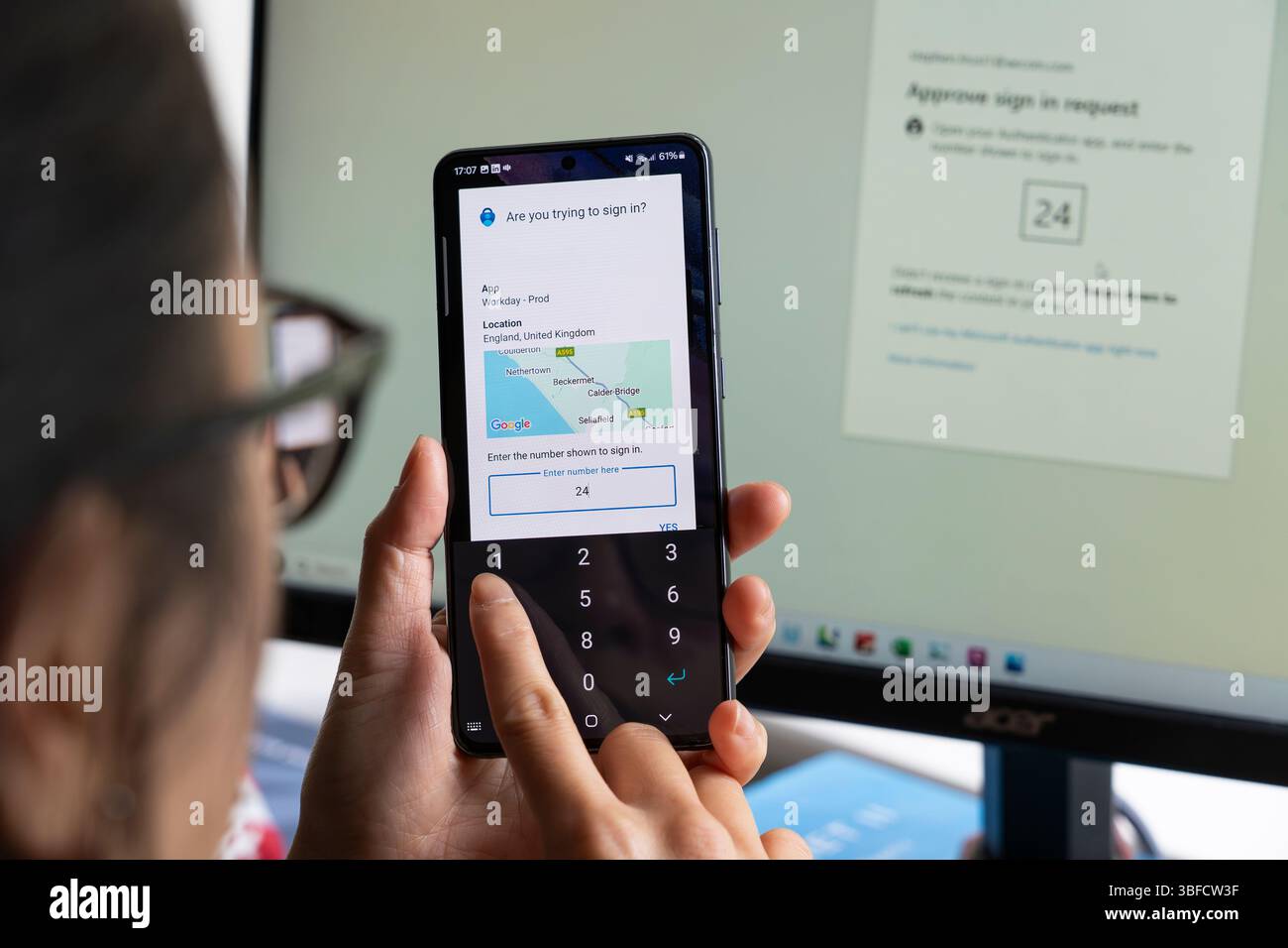 A woman working from home entering a number on the Microsoft ...