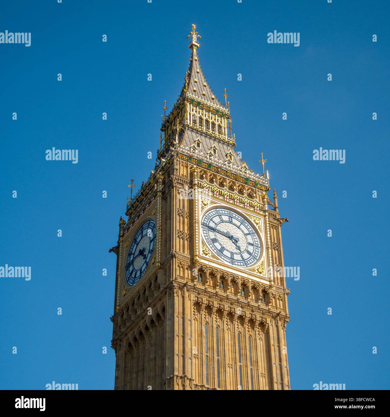 View of Big Ben tower from below with clear blue sky background ...